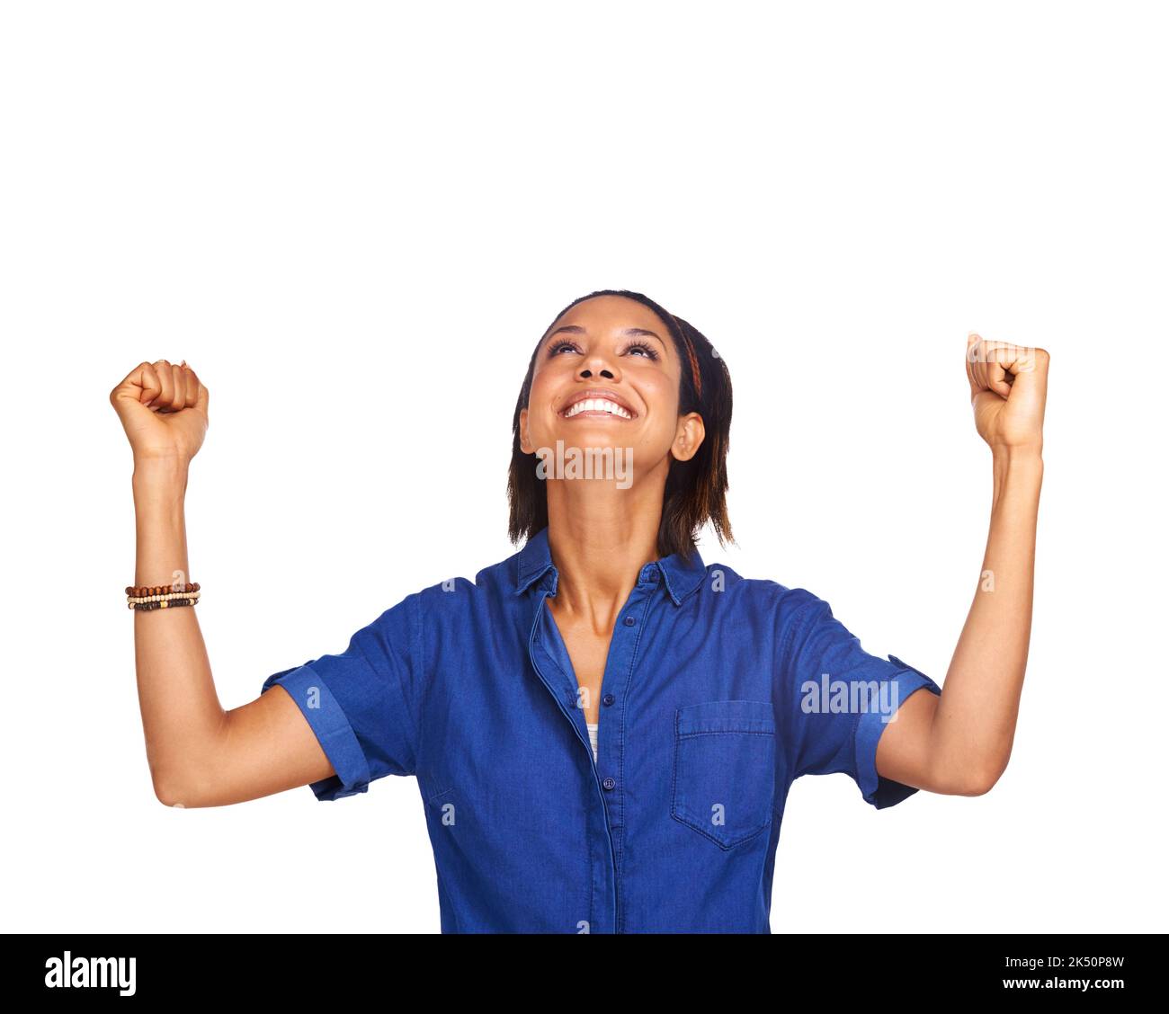 Yess. an attractive young woman raising her arms in celebration Stock ...