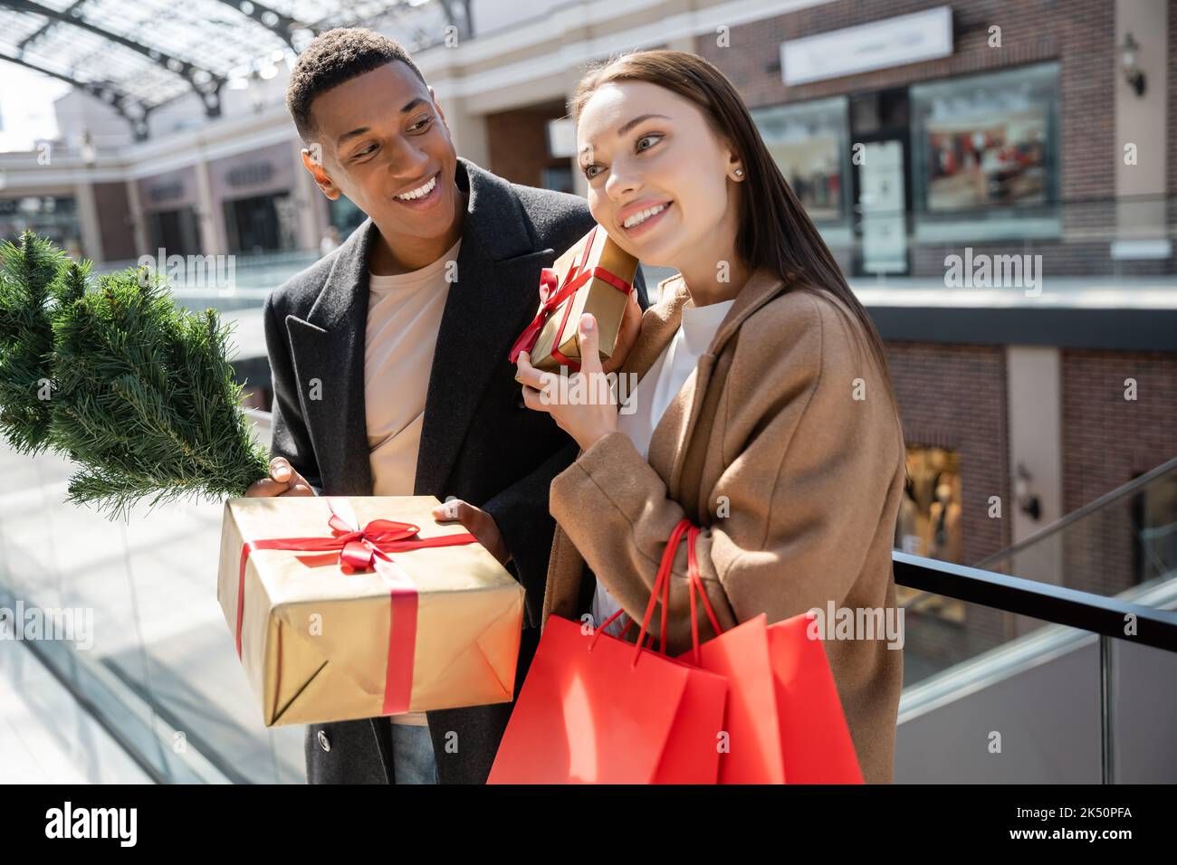Woman shaking gift box hi-res stock photography and images - Alamy