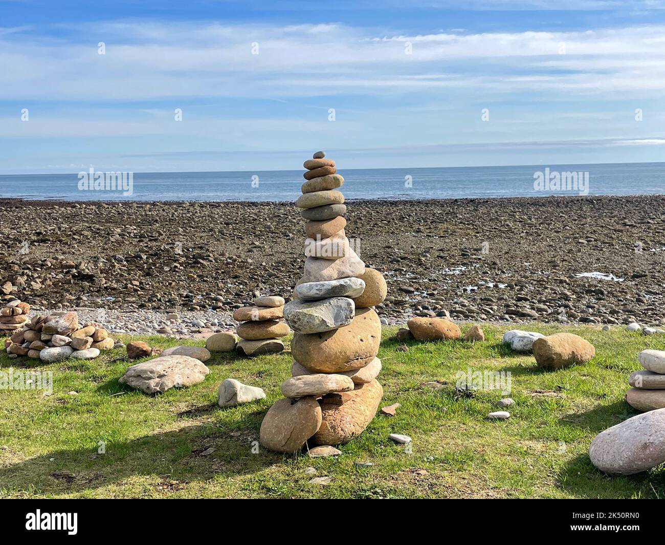 A Rock stacking on grass in Holy Island, England Stock Photo - Alamy