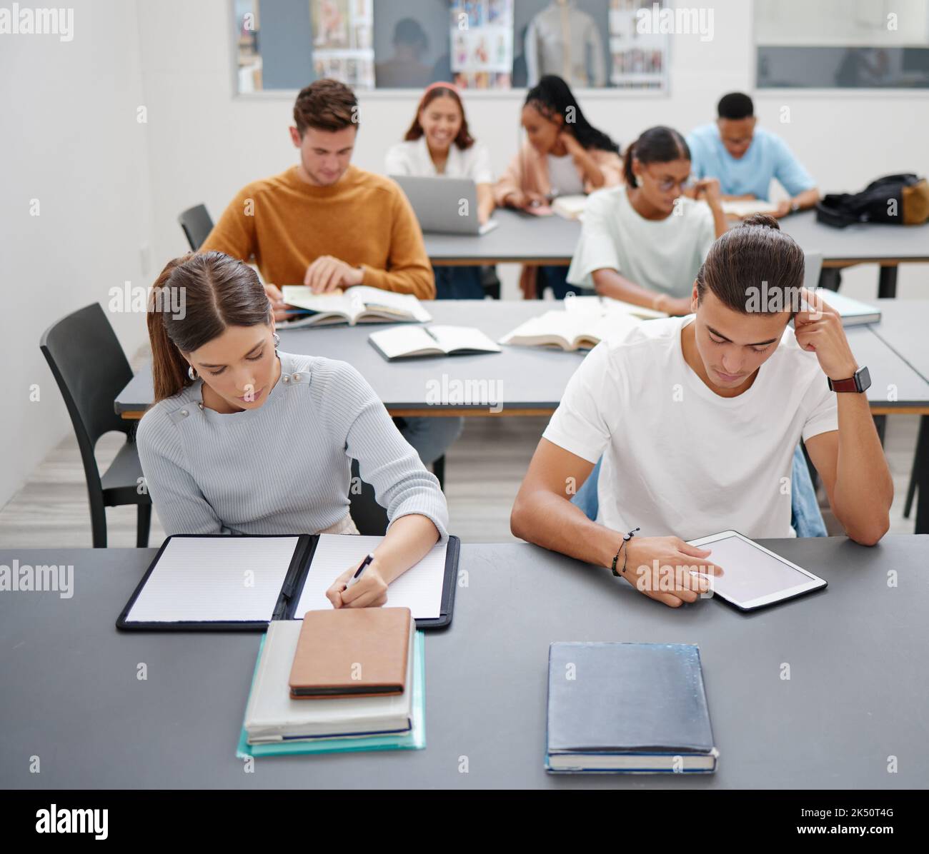 Studying, learning and students in university classroom with digital ...