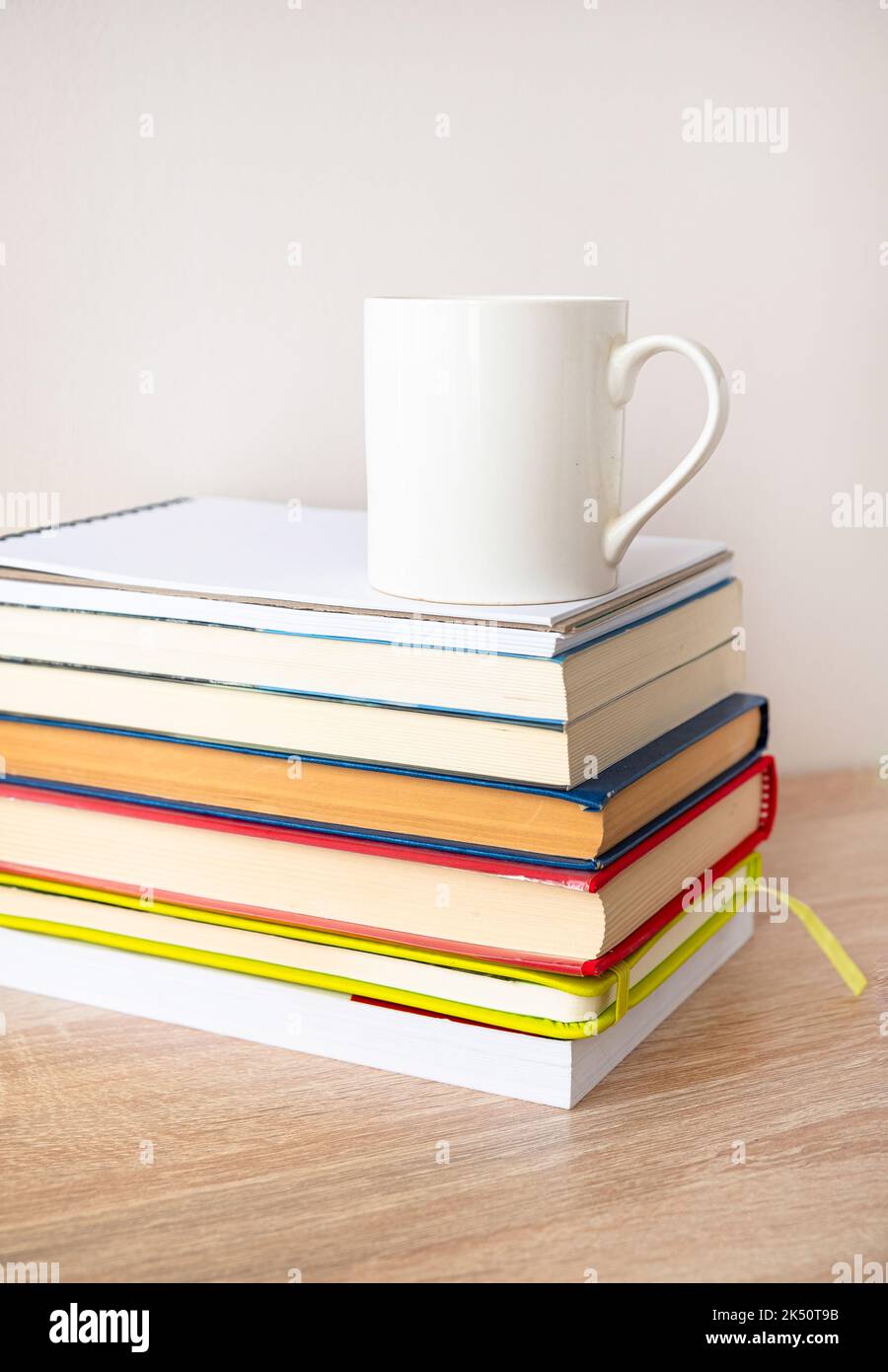 Stack of hardcover books with a white cup of coffee on the top Stock ...