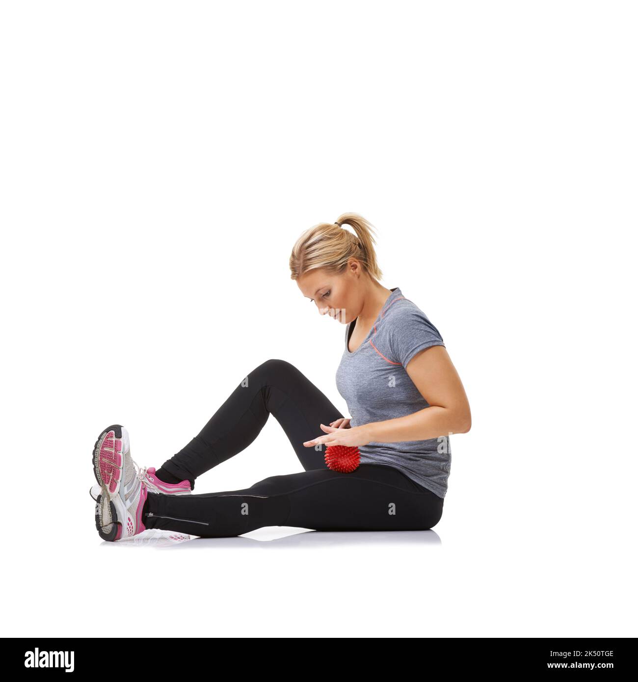 Firming up her thighs. A young woman getting in shape using an exercise ...