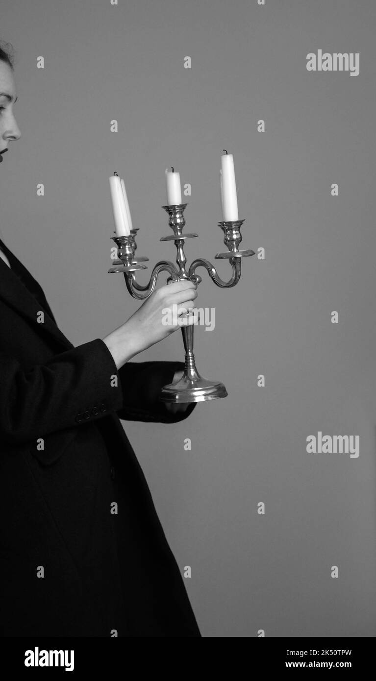 A vertical greyscale shot of an attractive female posing with a ...