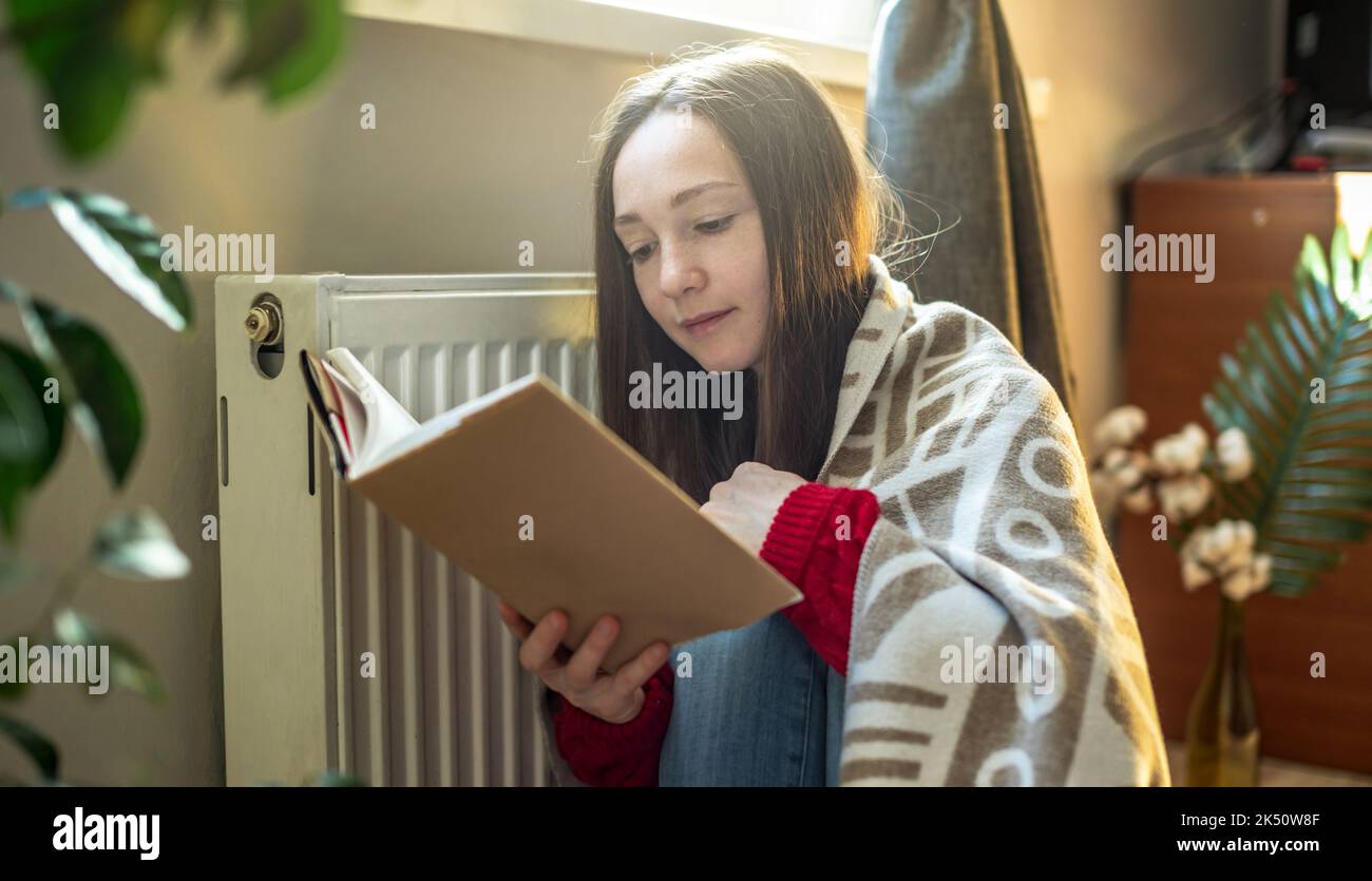 Woman warming herself heater hi-res stock photography and images - Alamy