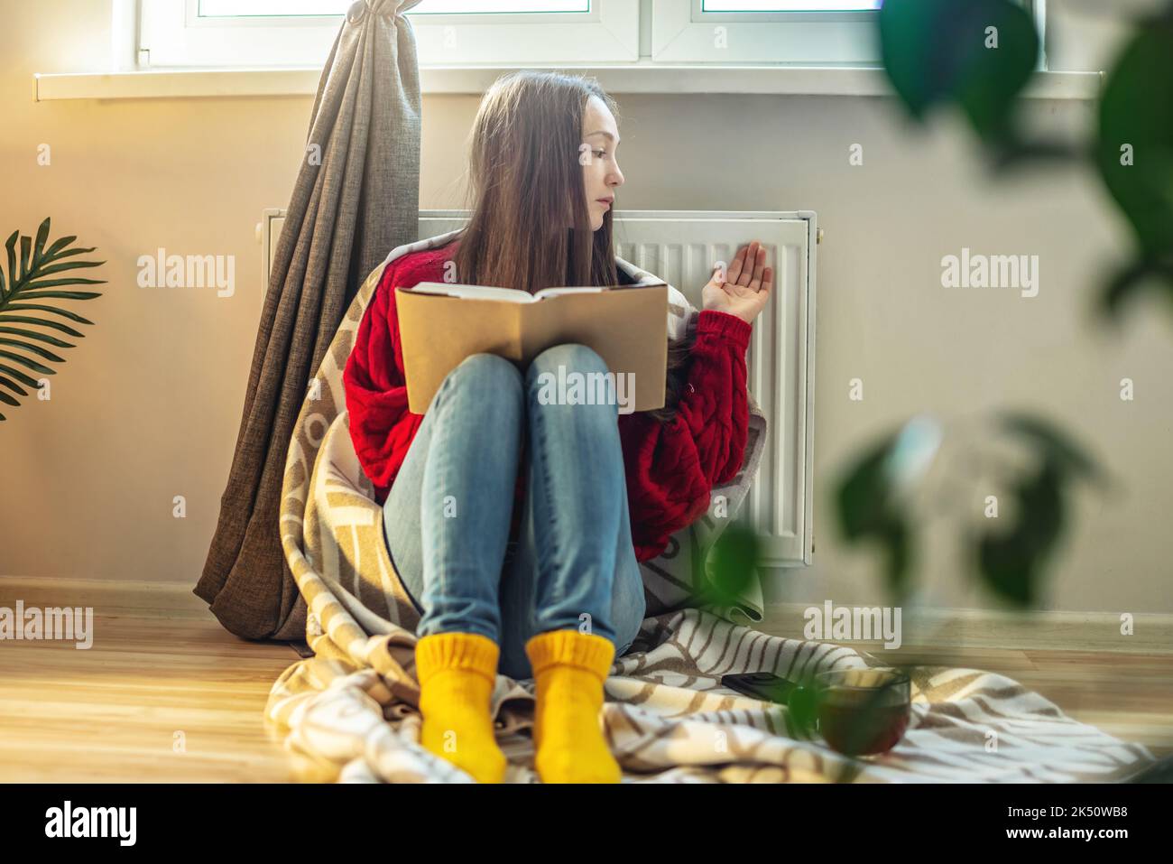 Woman warming herself heater hi-res stock photography and images - Alamy