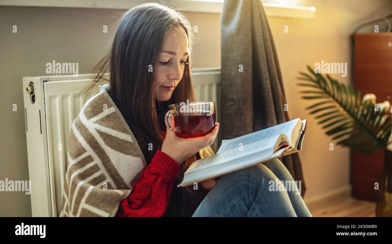 Woman warming herself heater hi-res stock photography and images - Alamy