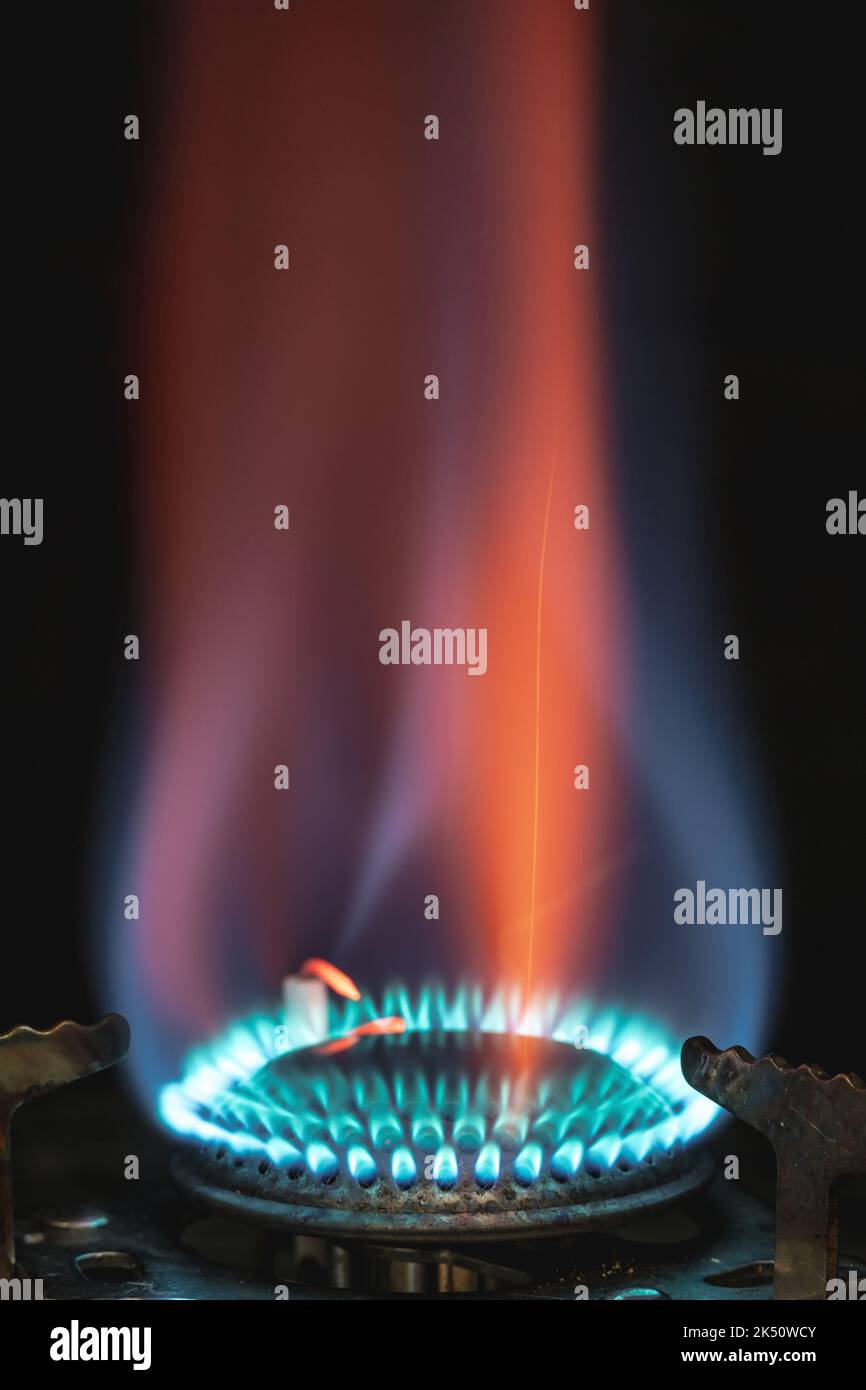 Blue flame of burning gas fire on a dark background. Gas as an energy ...