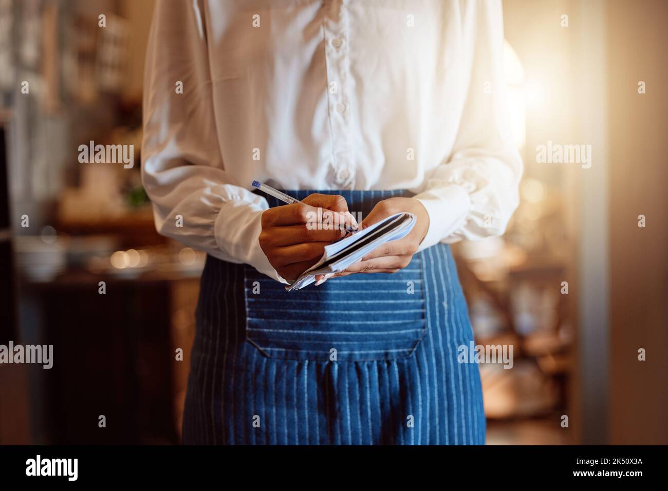 Food order, restaurant and hands of waiter writing notes on paper about ...