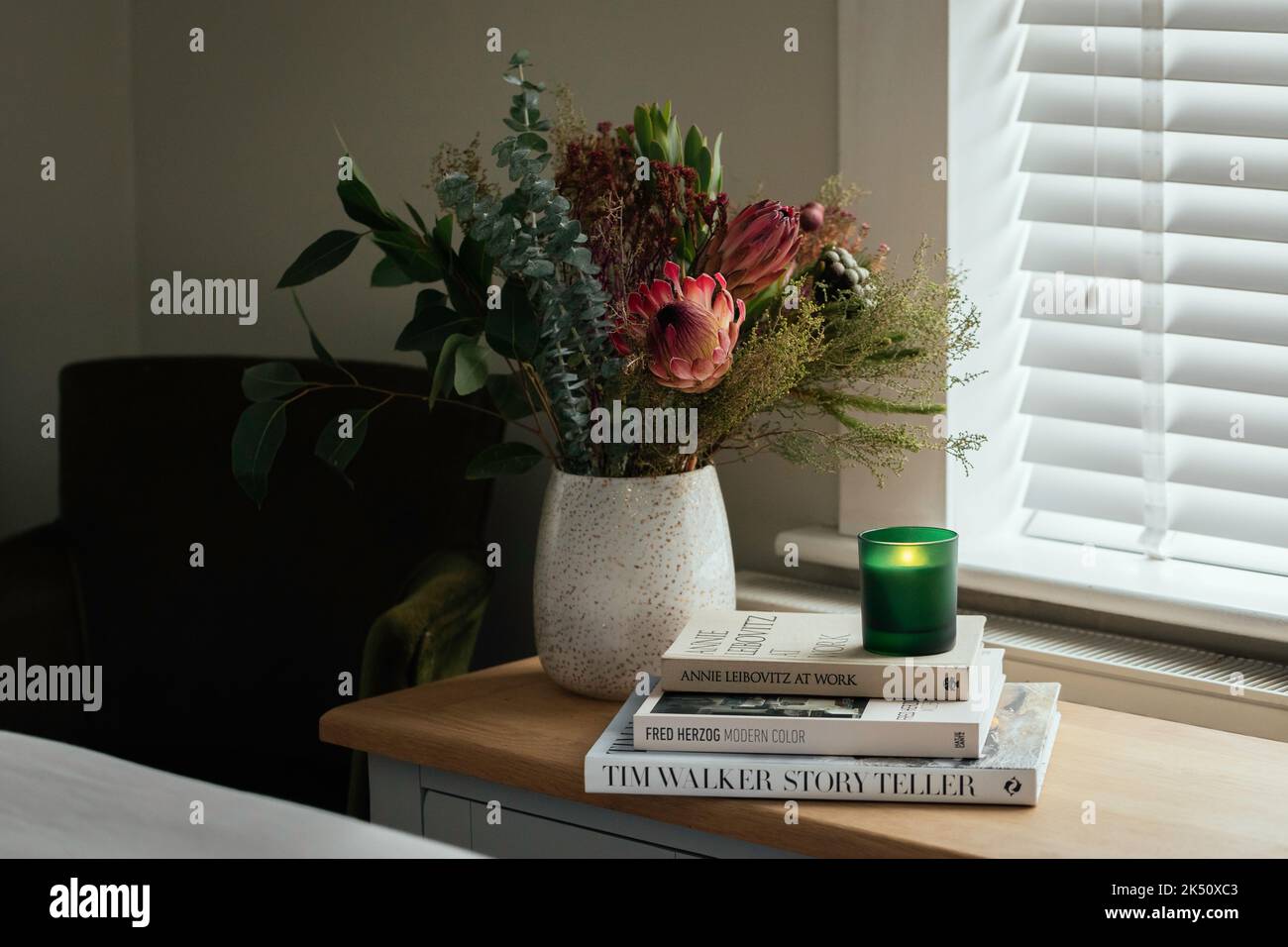 Soy Candle in a Green glass jar sat on a book stack in the bedroom ...