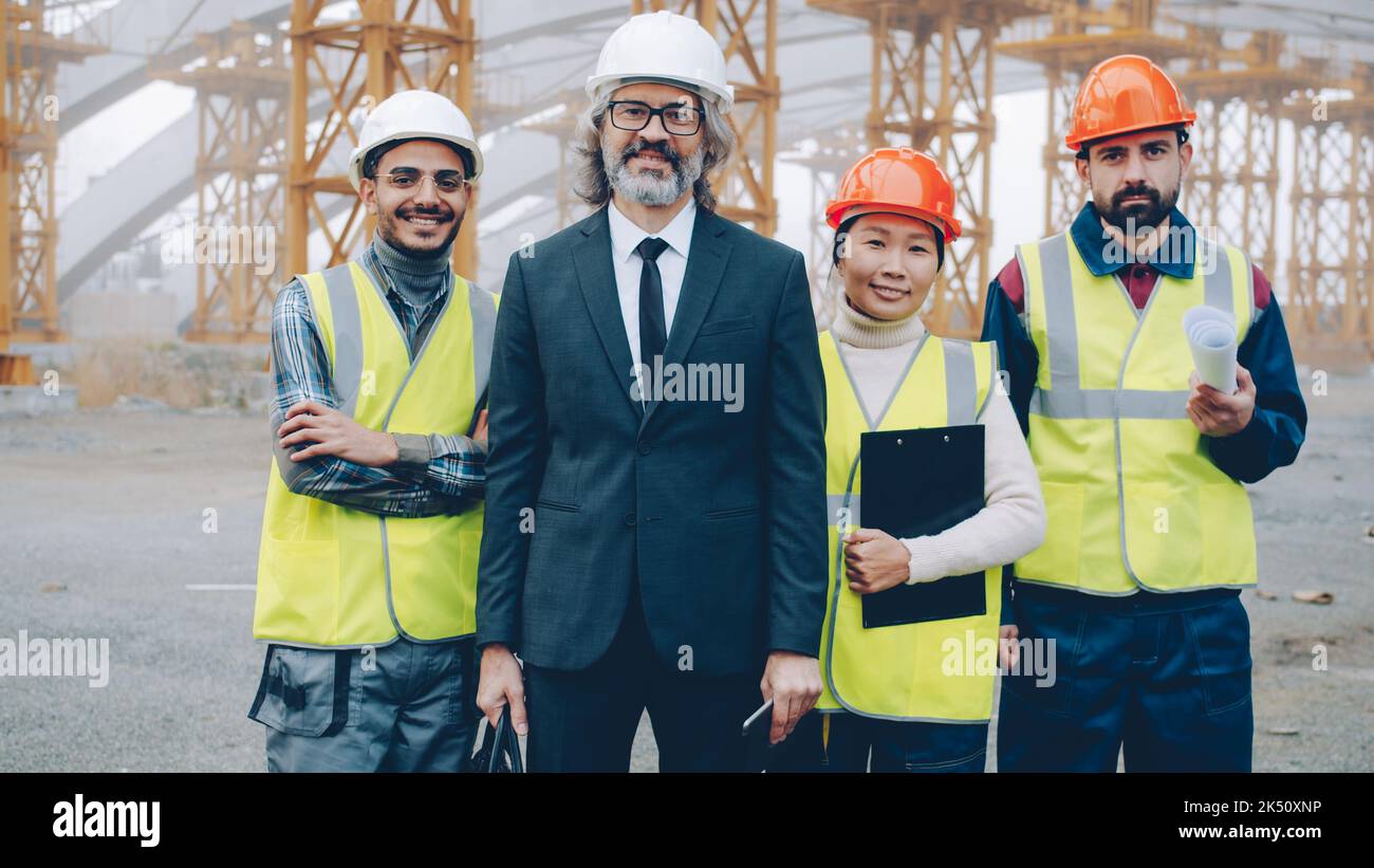 Diverse group of people building team are standing outdoors in ...