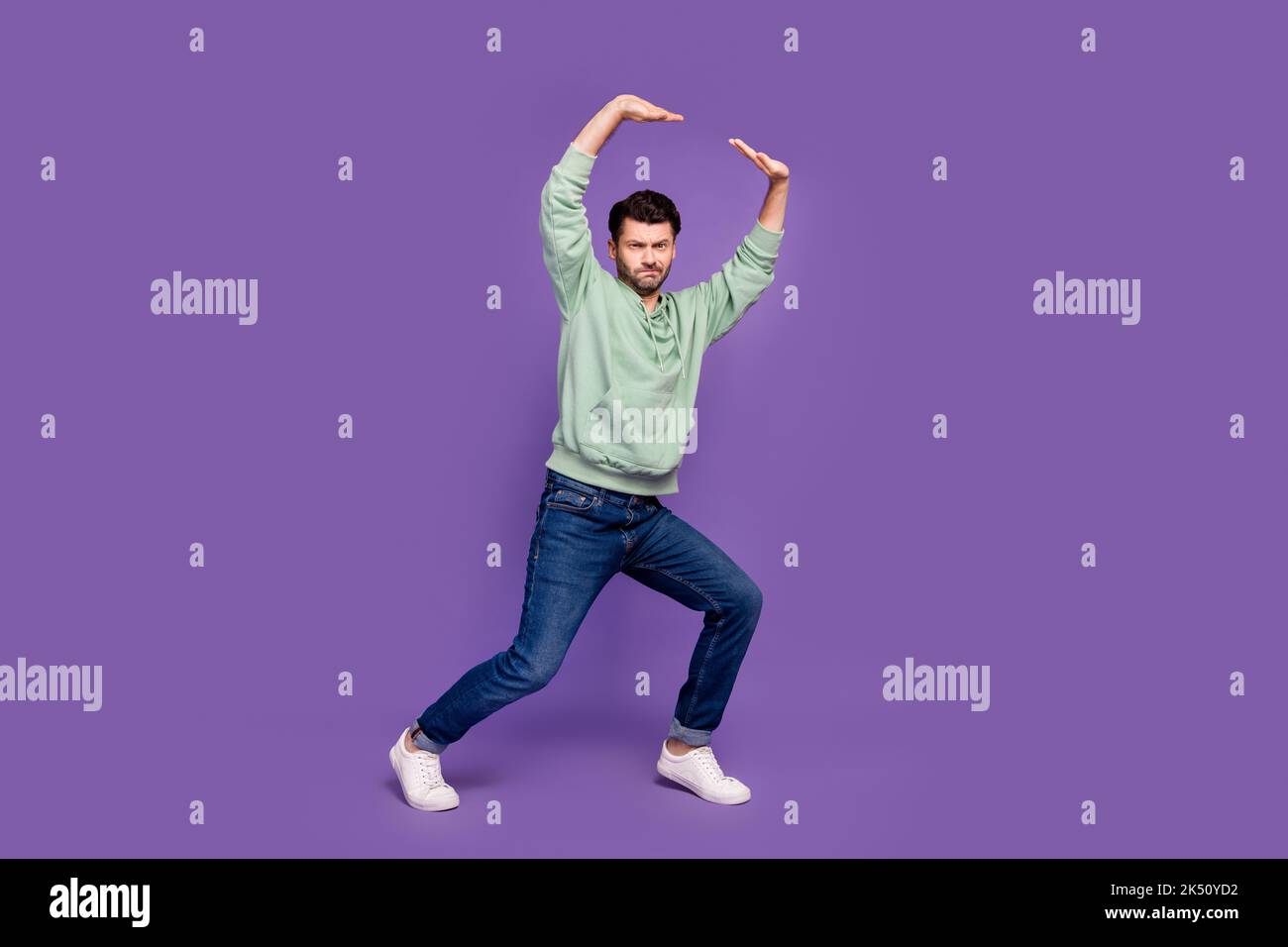 Full length photo of nice young man hold falling wall dissatisfied ...