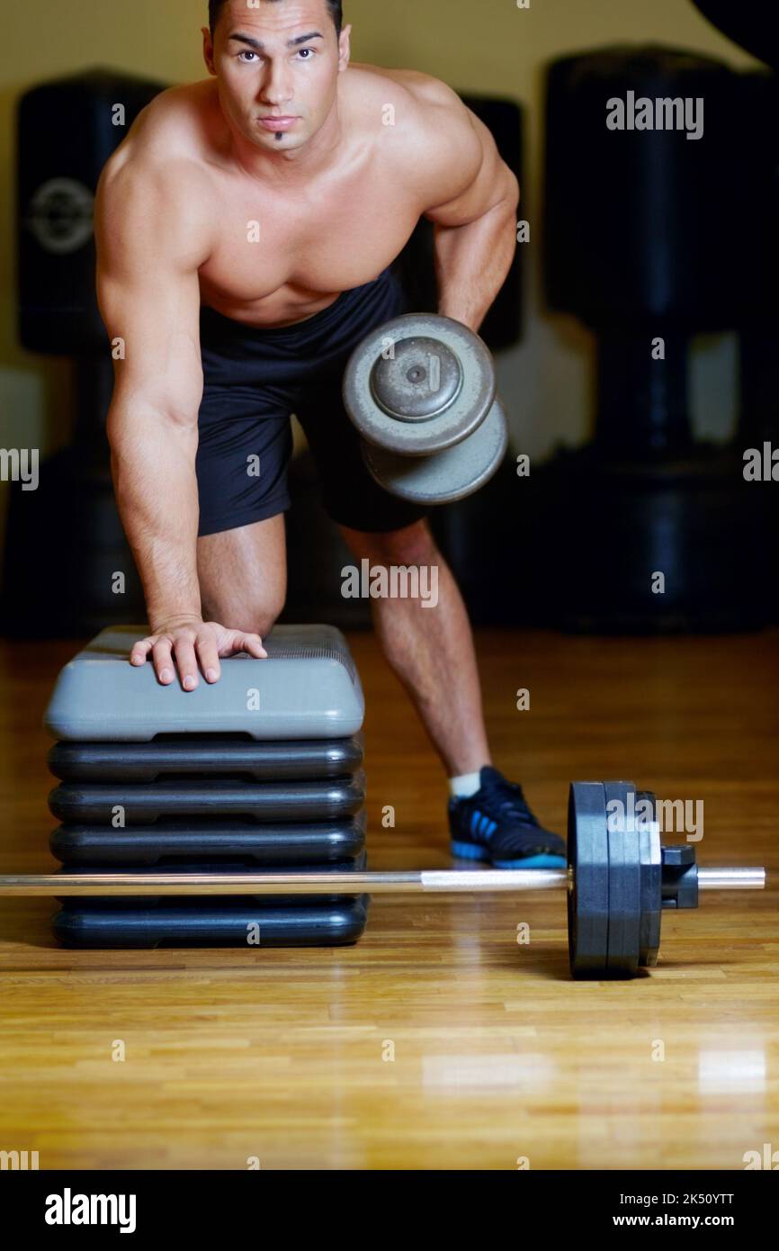 Owning this workout. A muscular young man working out in the gym Stock ...