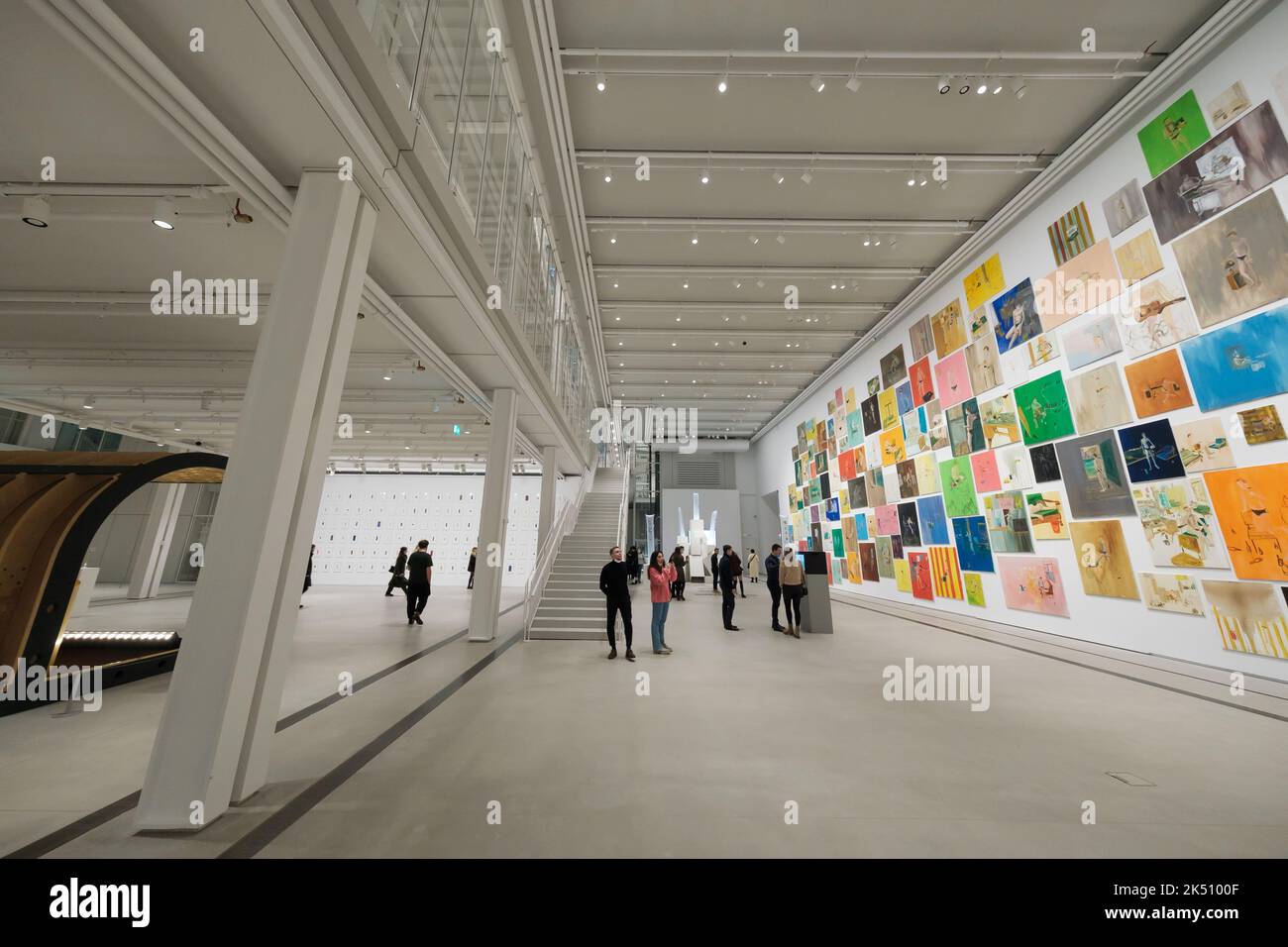 People admiring drawings in spacious hall Stock Photo - Alamy