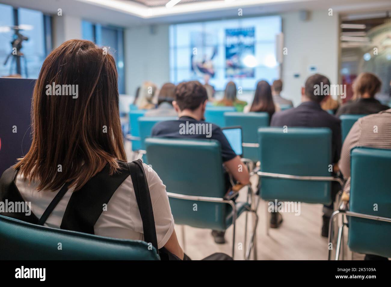 Anonymous young female watching presentation Stock Photo - Alamy