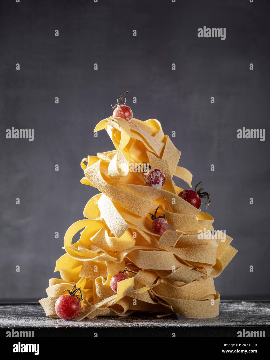 Christmas tree made by noodles and cherries tomatoes Stock Photo - Alamy