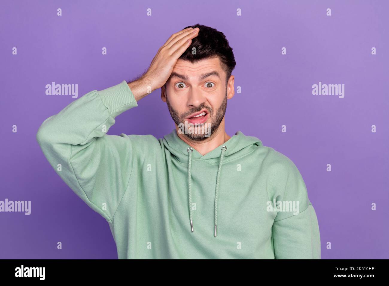 Photo of young funny excited nervous unhappy man wear khaki hoodie ...