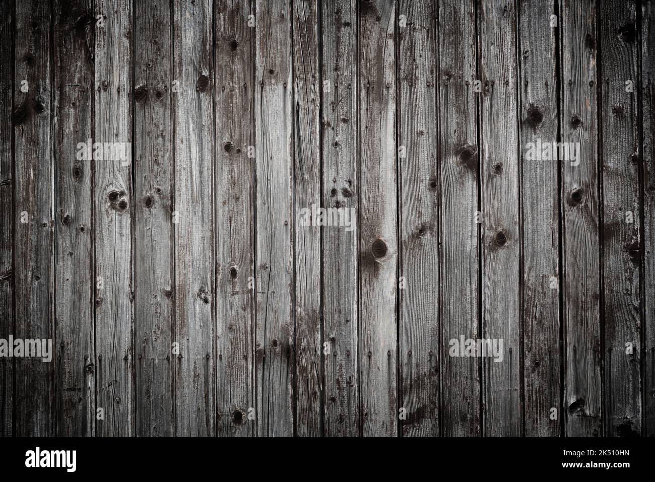 Old dark gray rustic wooden wall background planks weathered with nails ...