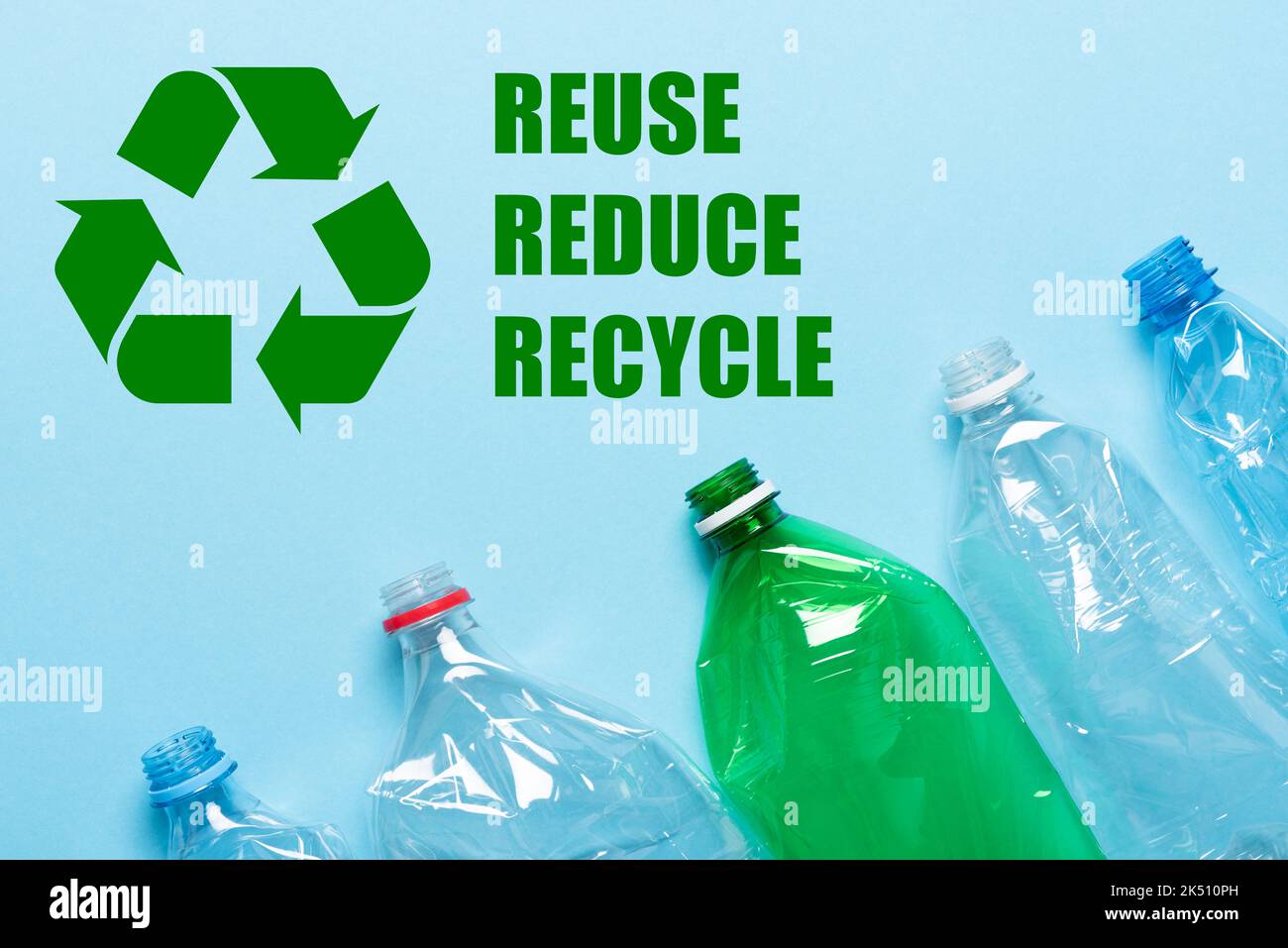 Recycling symbol with reuse reduce recycle text and plastic bottles on ...