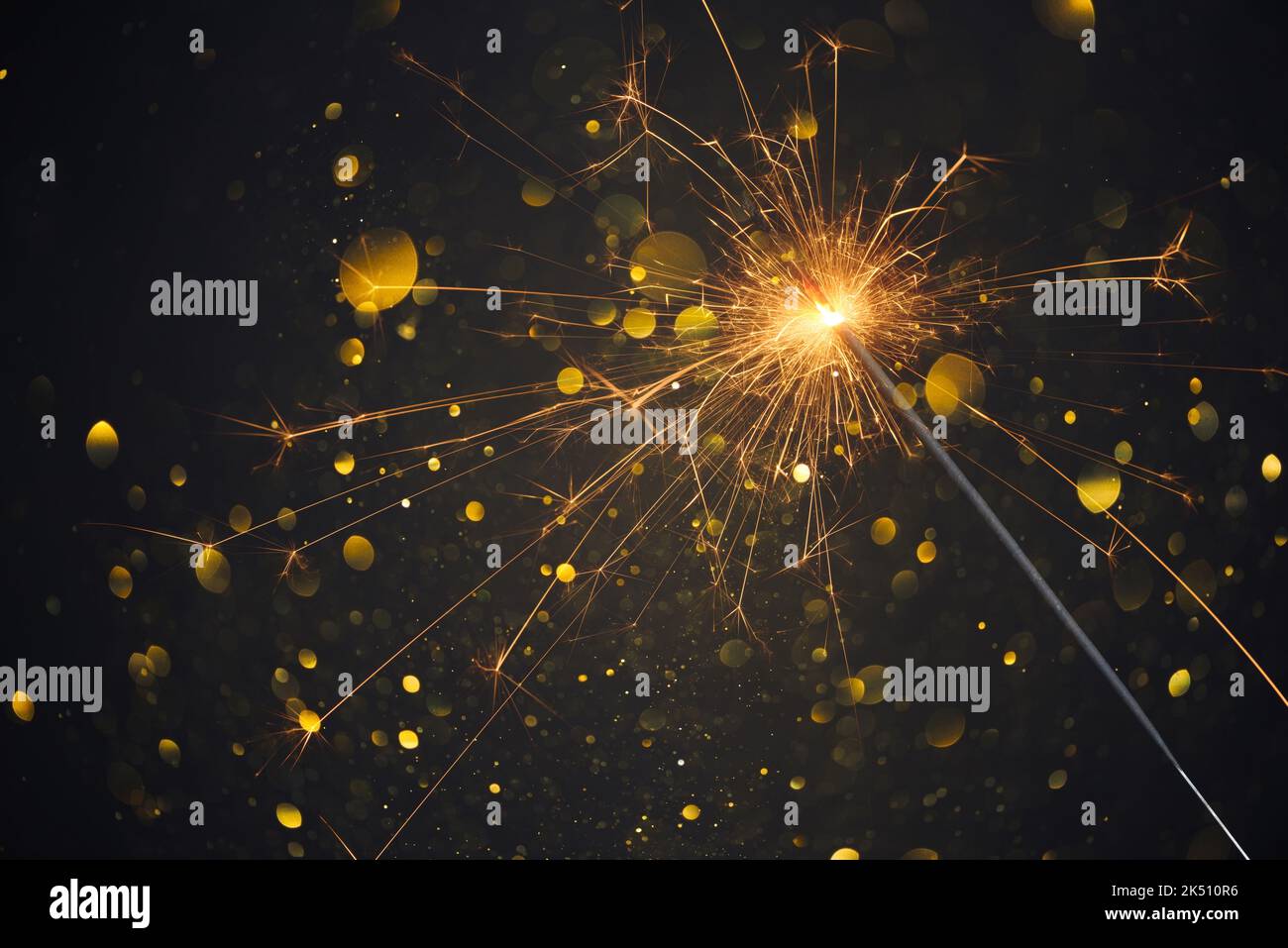 Happy New Year, Sparkler burning bright with shiny sparks and bokeh ...