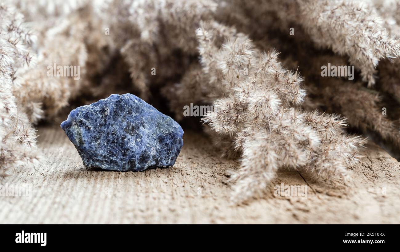 Sodalite crystal stone specimen on wooden background. Sodalite is a ...