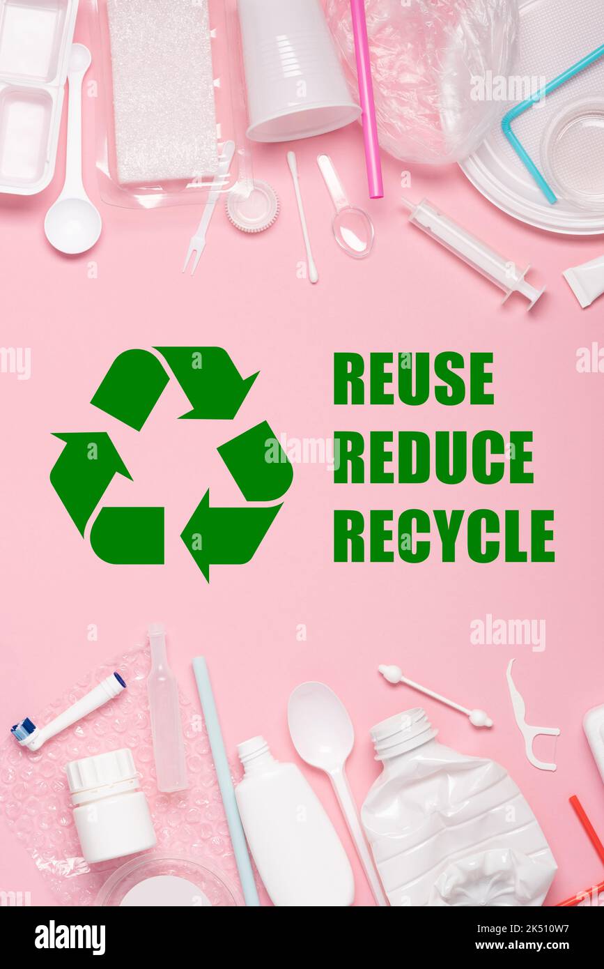Plastics on pink pastel background with recycling symbol and reuse ...