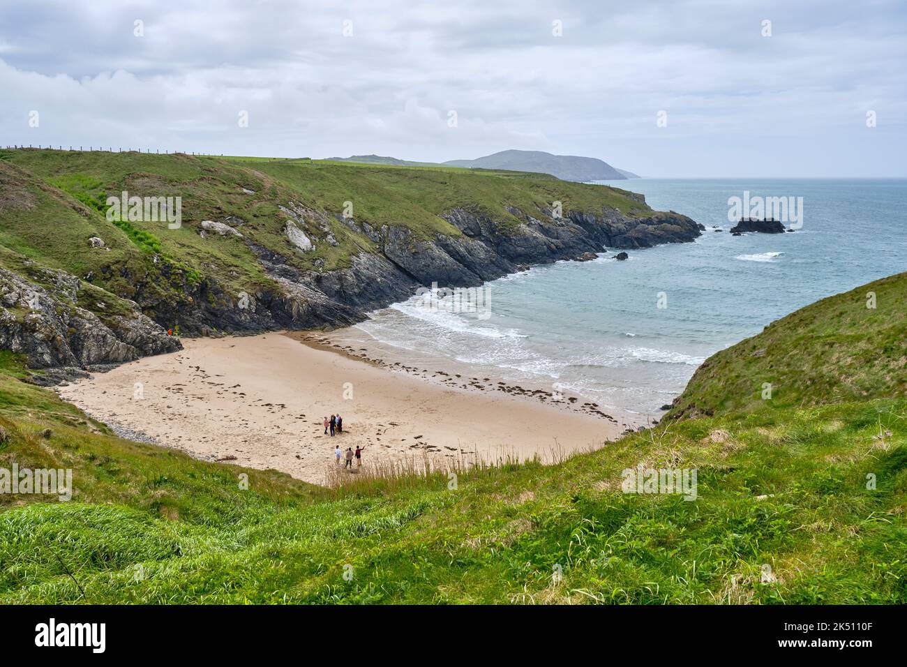 Groups of people standing on the beach at Porth Lago on the Llyn ...