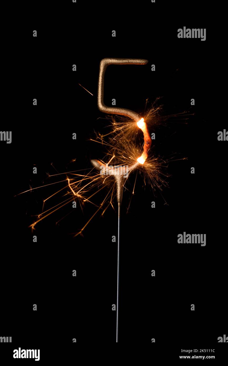 Burning golden sparkler in shape of number five, digit 5, isolated on ...