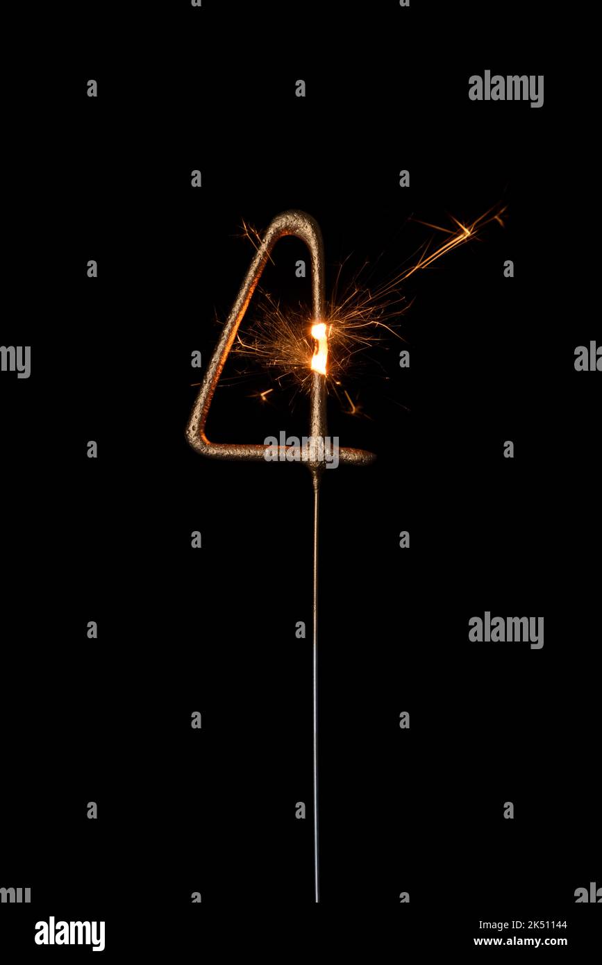 Burning golden sparkler in shape of number four, digit 4, isolated on ... Burning golden sparkler in shape of number four, digit 4, isolated on ...