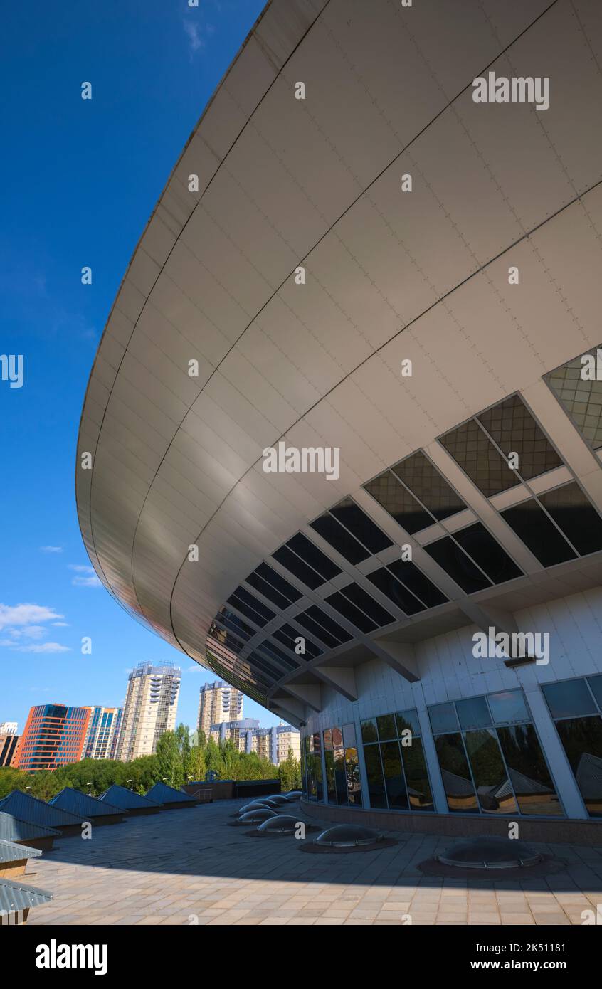 Exterior view of the round, circular, silver, shiny, modern, flying ...