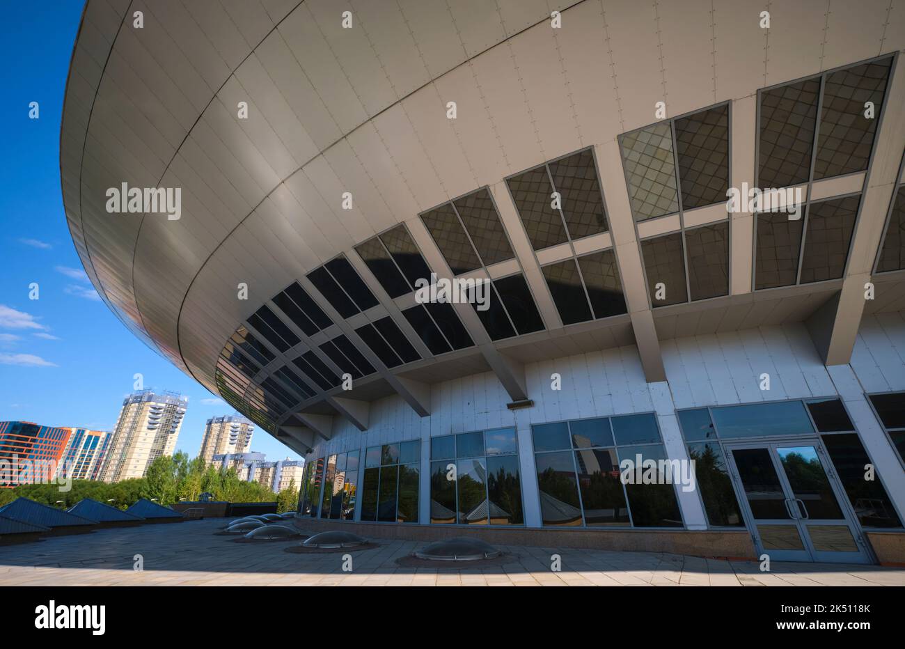 Exterior view of the round, circular, silver, shiny, modern, flying ...