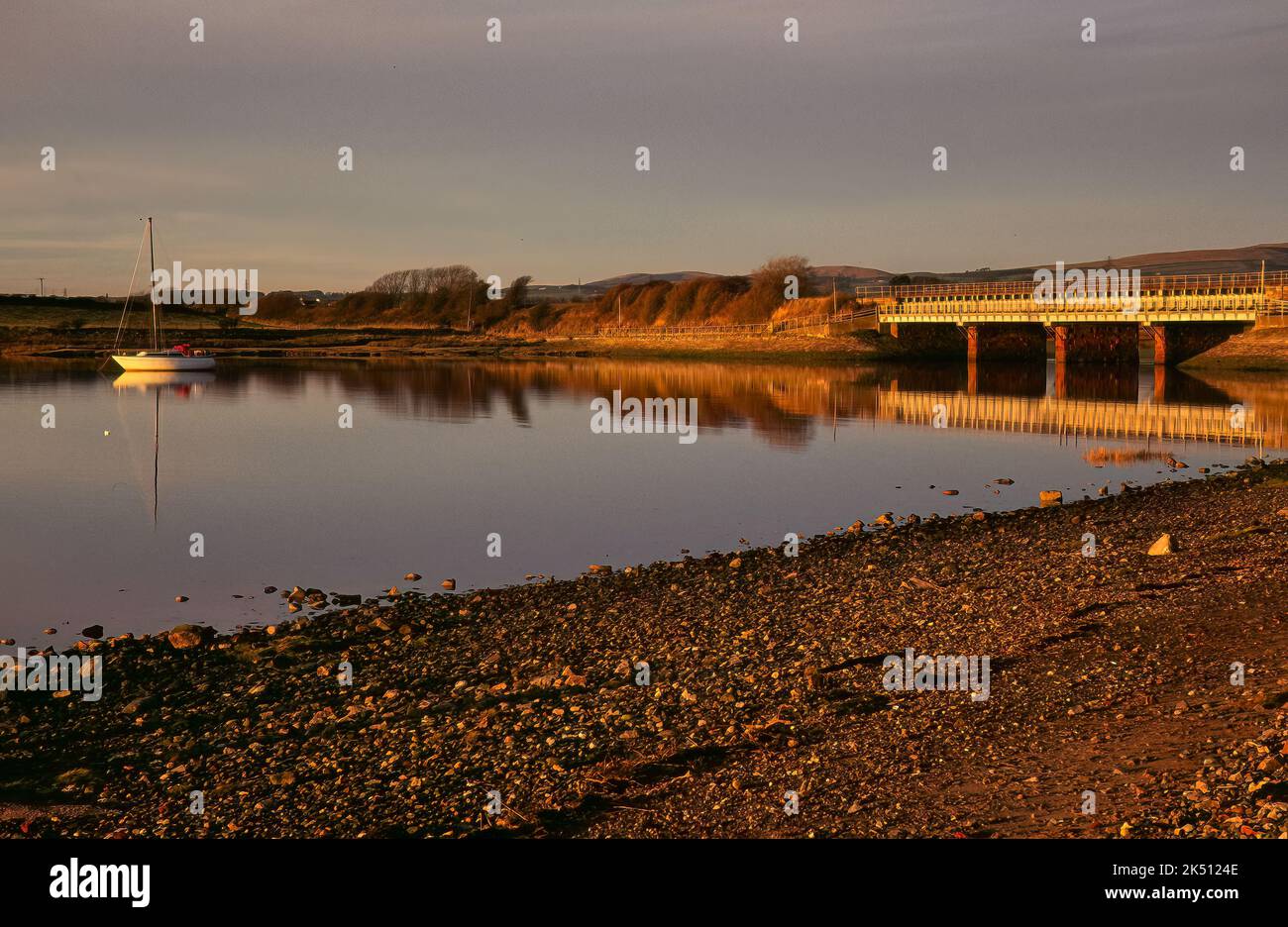 A boat in the river Mite during the sunset at Ravenglass estuary in ...