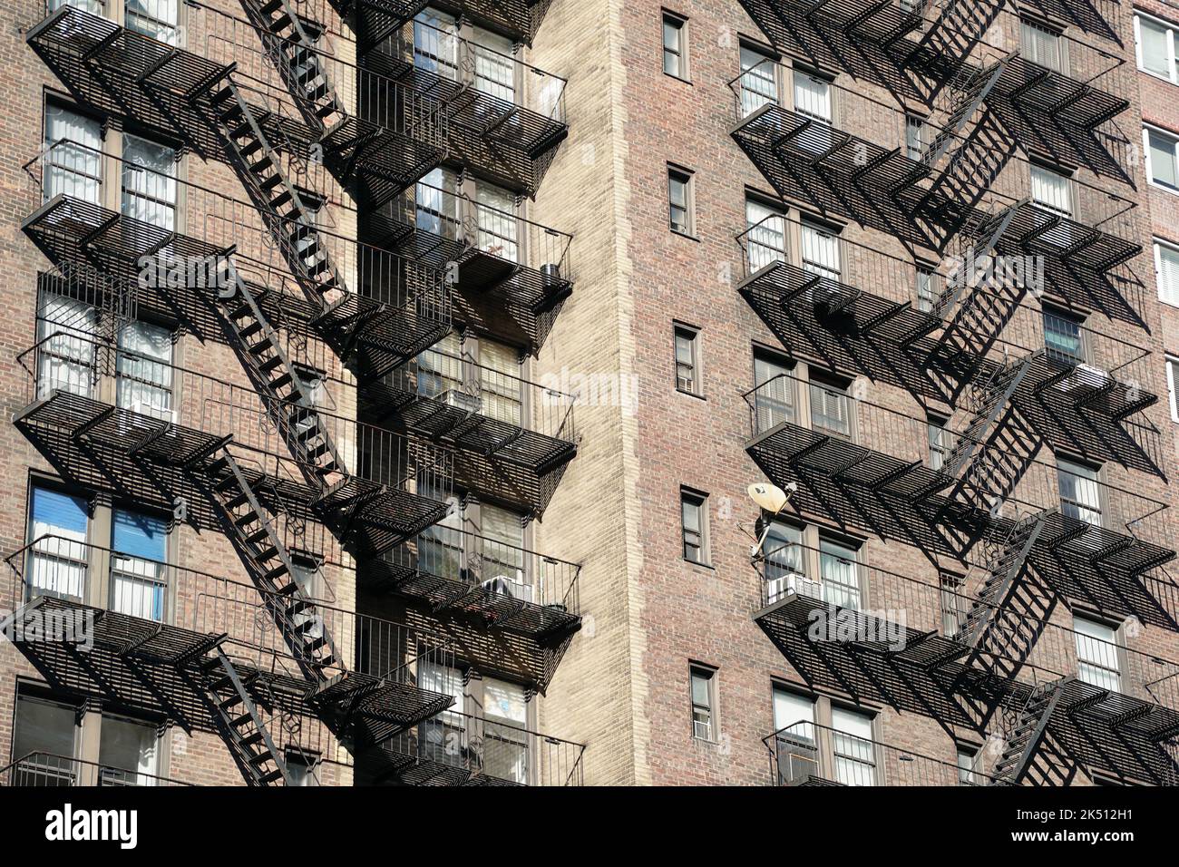 new york city building fire escape ladders Stock Photo - Alamy