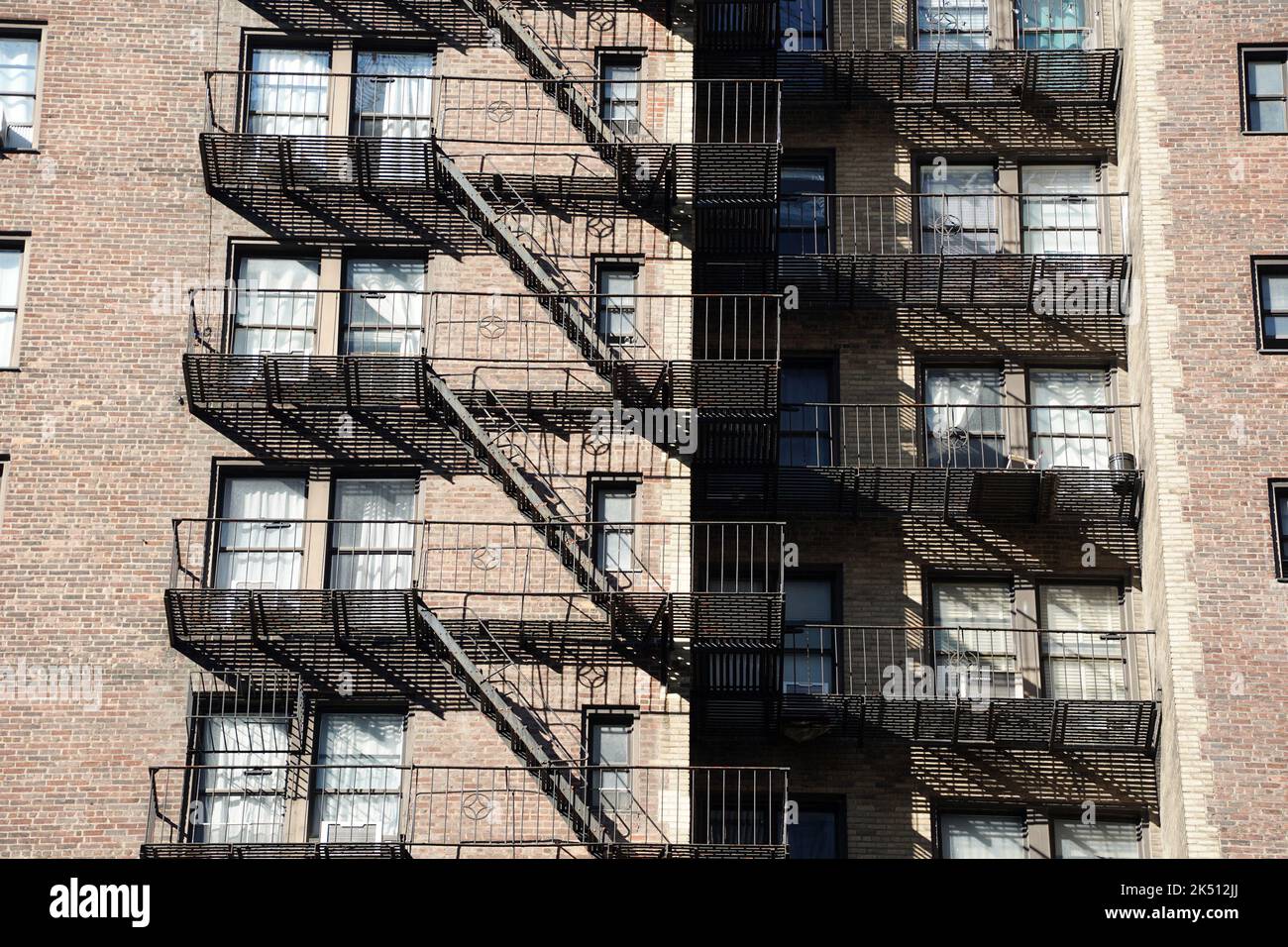 new york city building fire escape ladders Stock Photo - Alamy