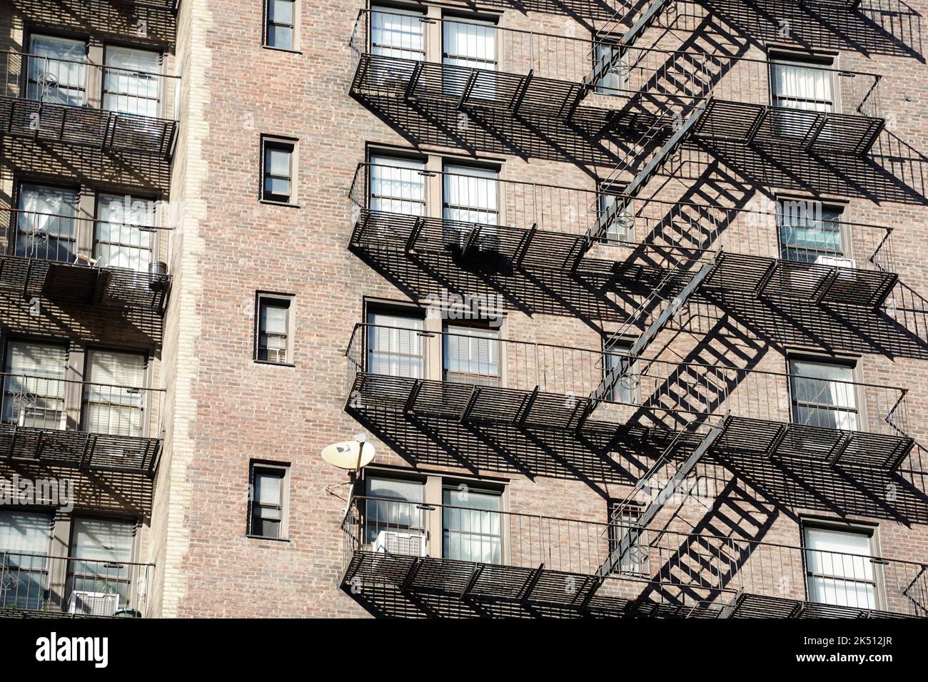 new york city building fire escape ladders Stock Photo - Alamy
