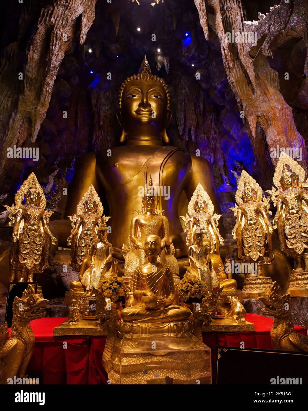 Golden buddha image statue and naga guardian of Wat Maniwong for thai ...