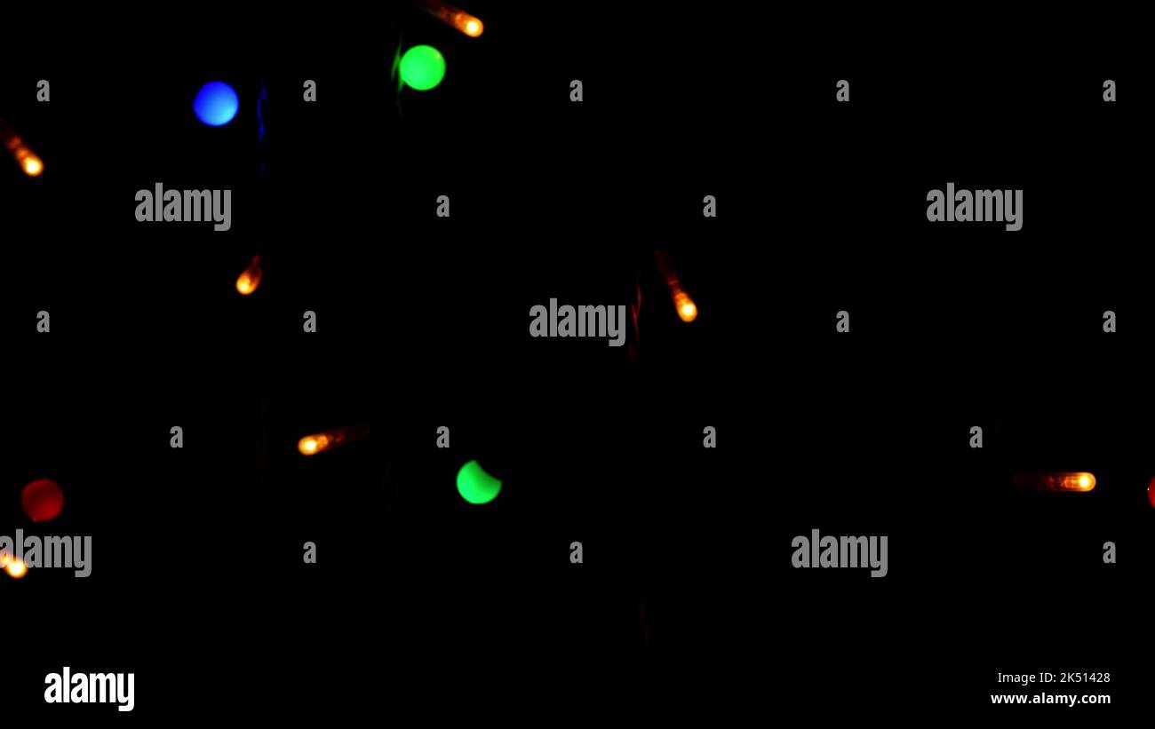 Multicolored garland lights on black background. New year or Christmas ...