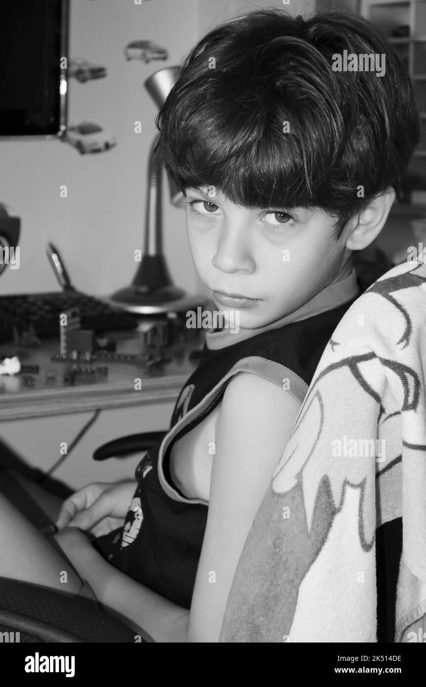 Black and white portrait of a quiet serious child in her bedroom ...