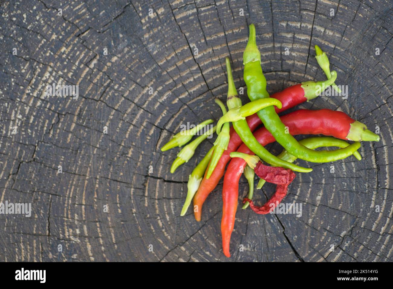 A top view of green and red chili peppers on a tree stump Stock Photo ...