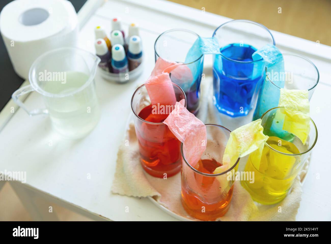 Cute baby boy learning mixing different colors with water and paint in ...