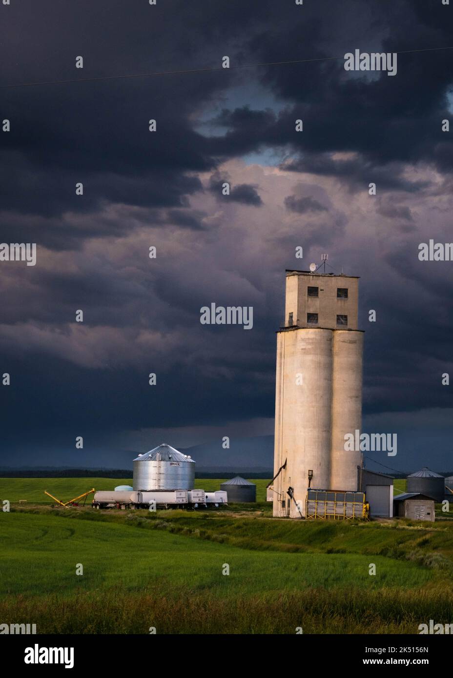 A vertical shot of a grain elevator under a storm Stock Photo - Alamy