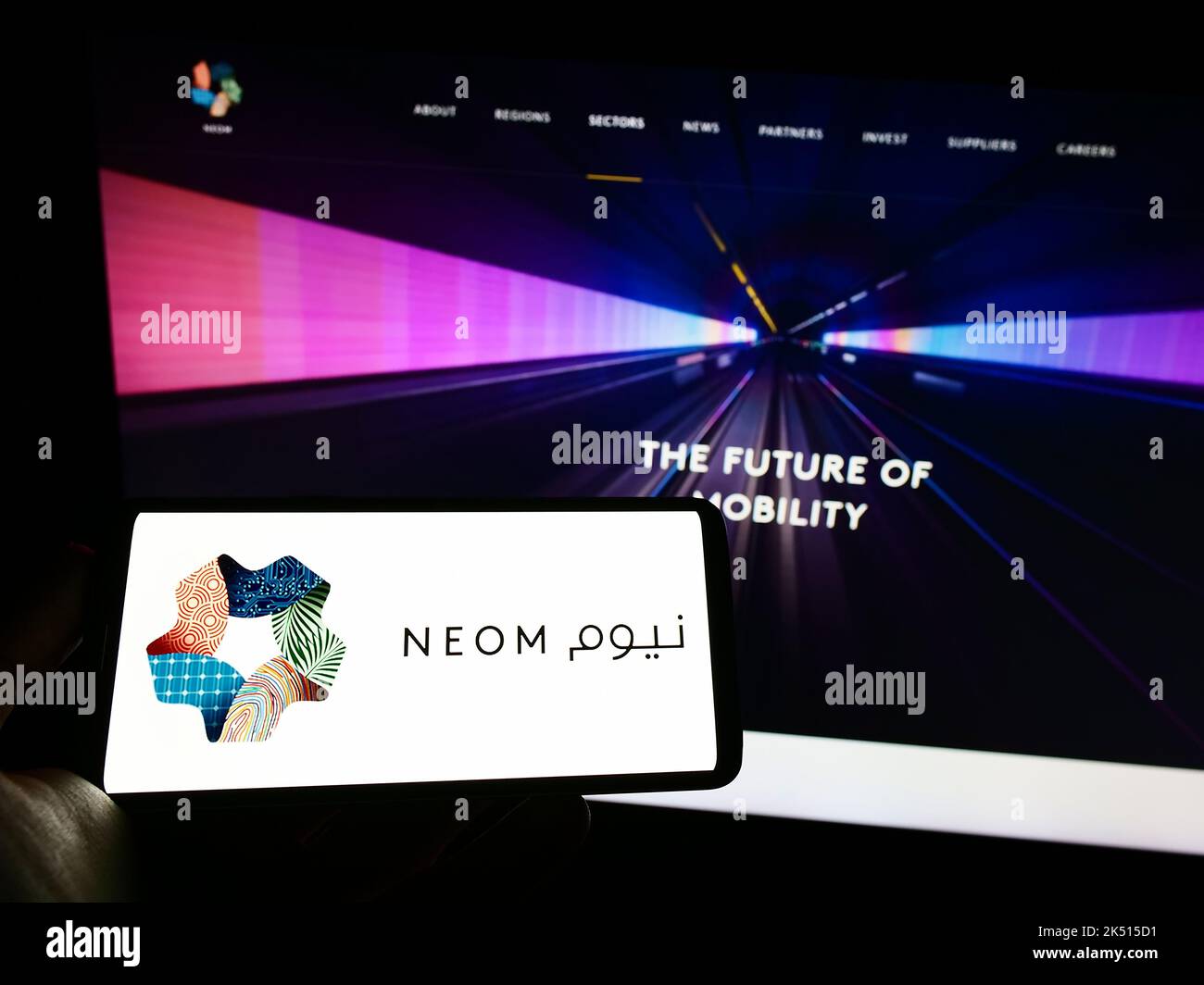 Person holding cellphone with logo of Saudi Arabian property developer ...