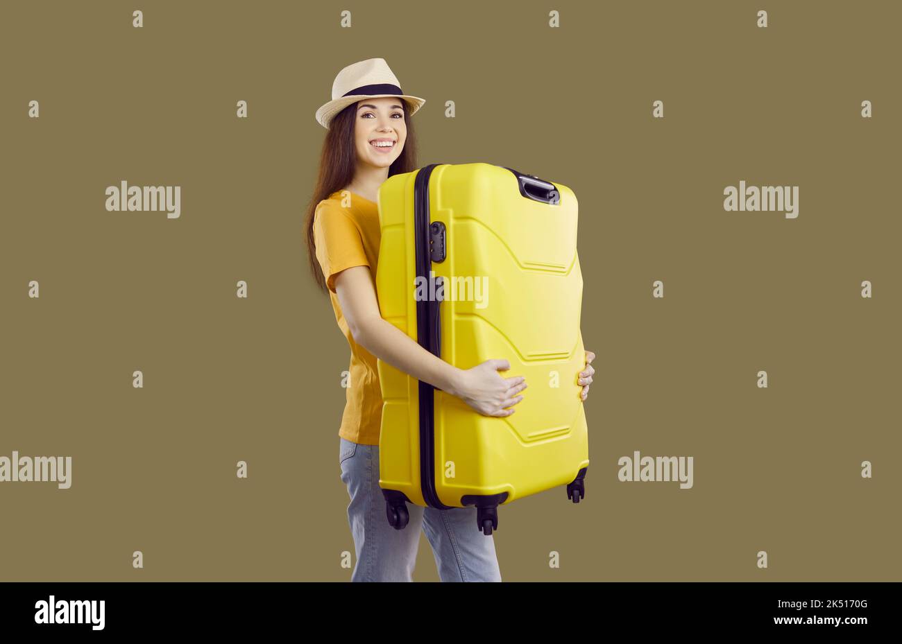 Happy Young Woman Who Is Going On Summer Holiday Is Carrying Her