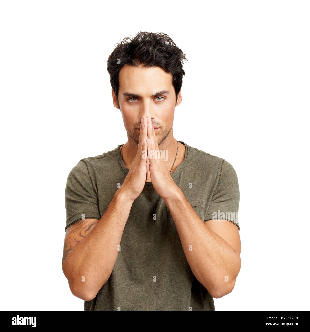 Thinking ahead. A handsome young man standing with his hands together ...