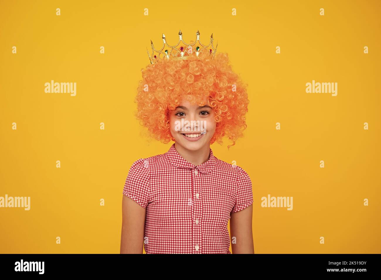 Little queen in wig wearing golden crown. Teenage girl princess holding ...