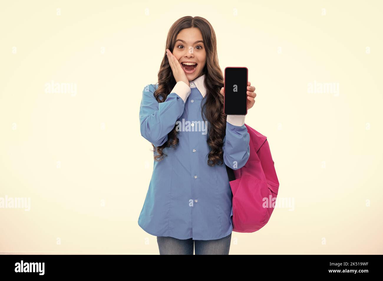 Excited face. Teenager school student girl with mobile phone on ...