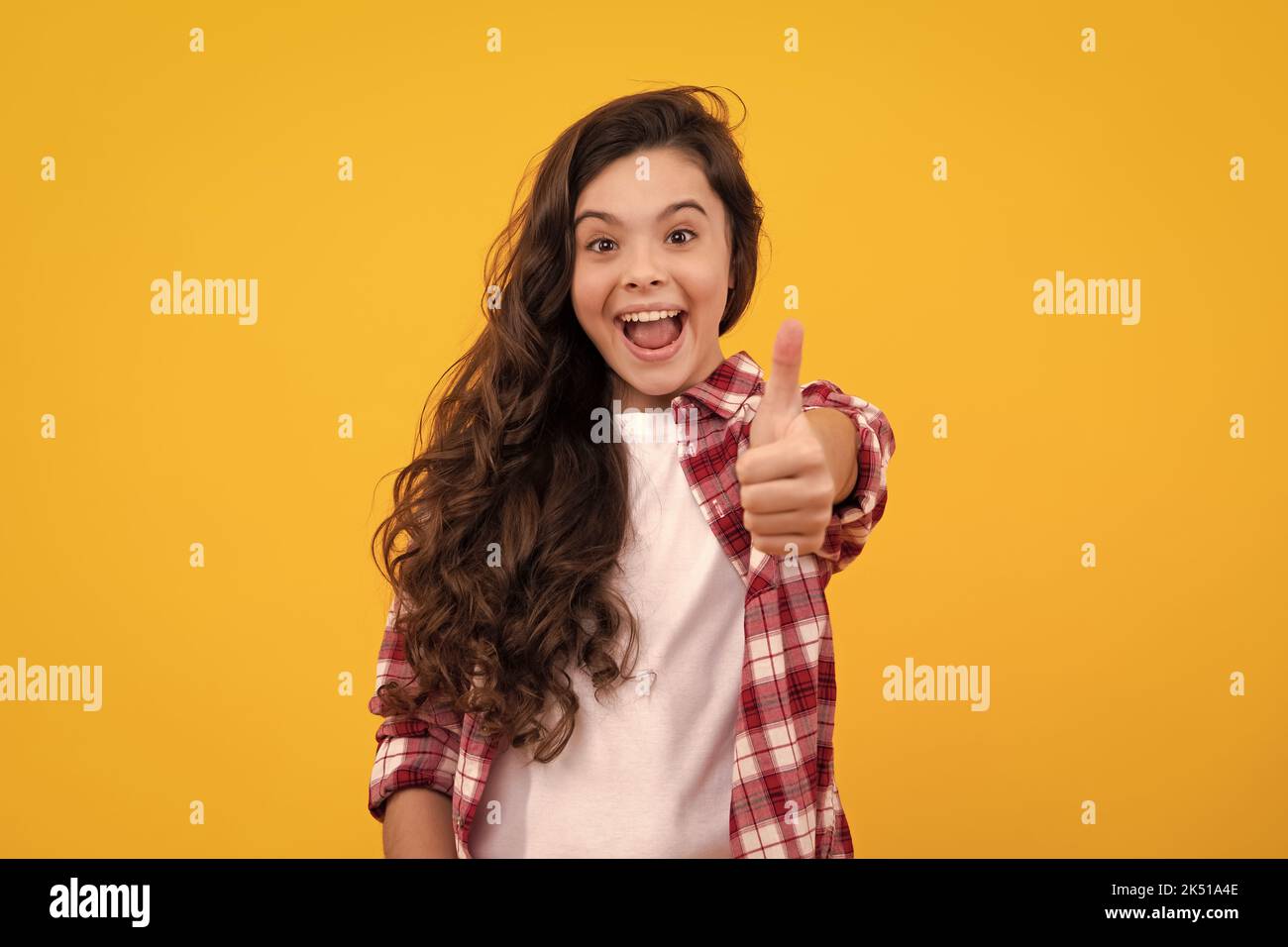 Amazed teenager. Happy funny teenager child girl show sight thumbs up ...