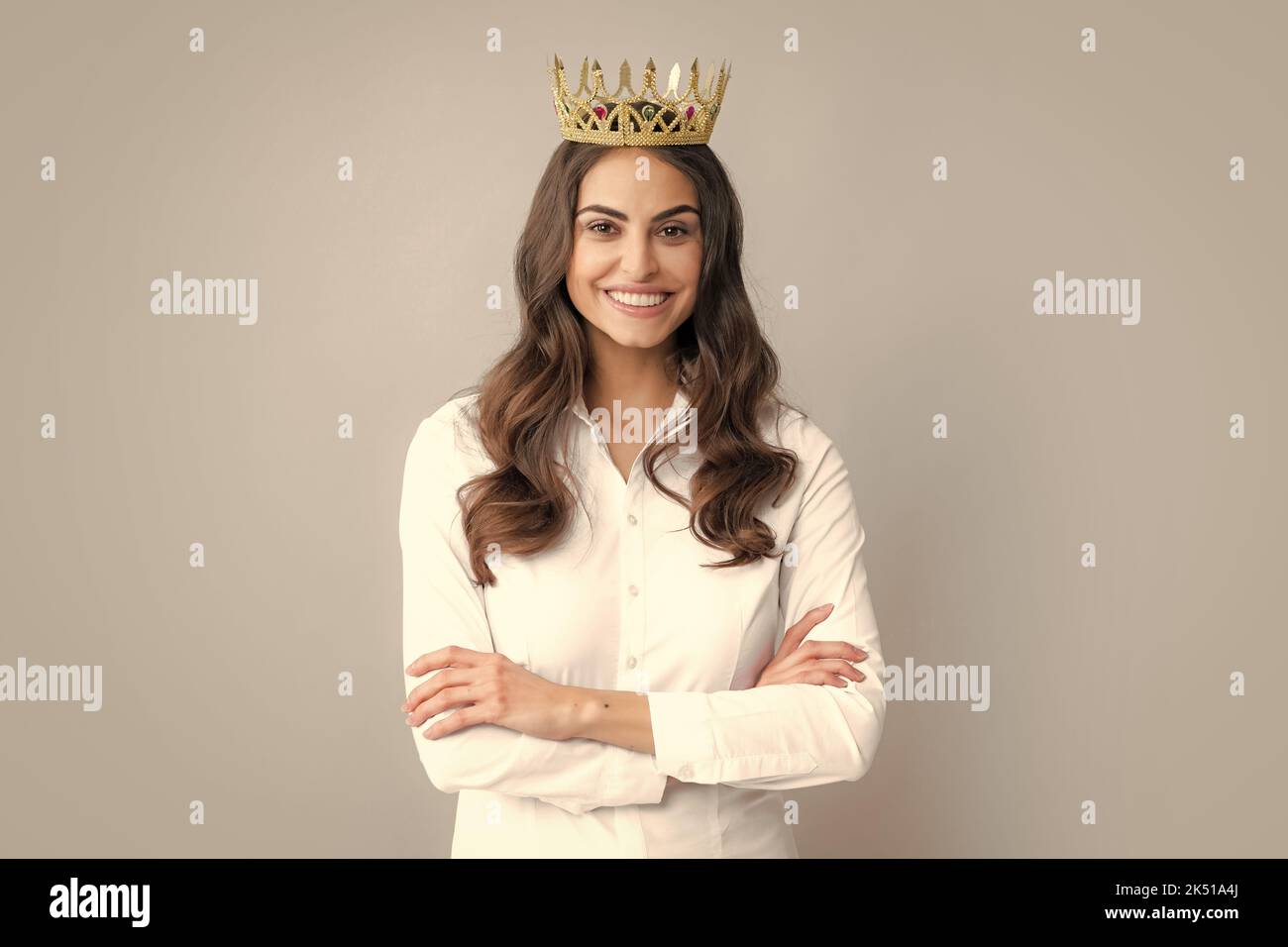 Young lovely woman in crown on gray background. Girl with queen crown ...