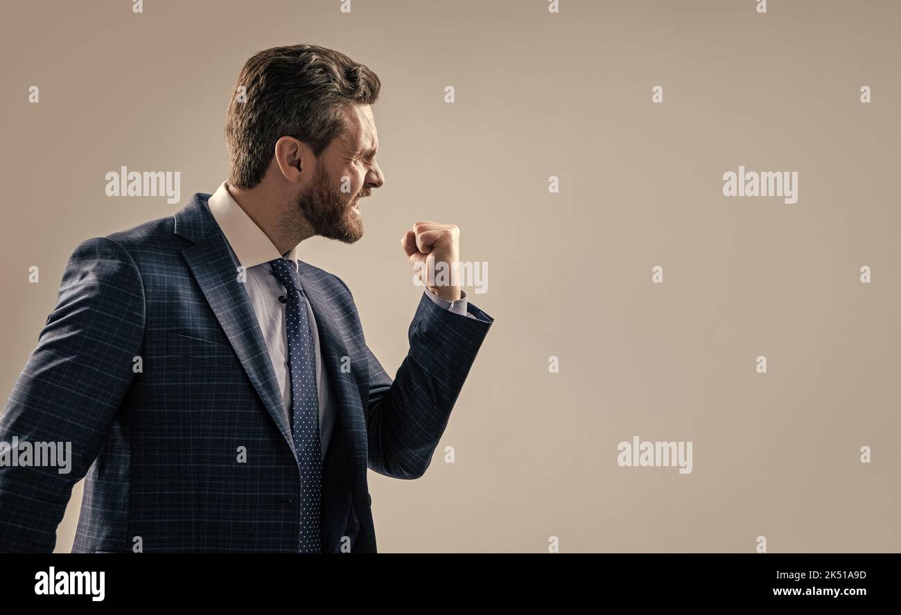 Aggressive man businessman in suit make threaten gesture shaking fist ...