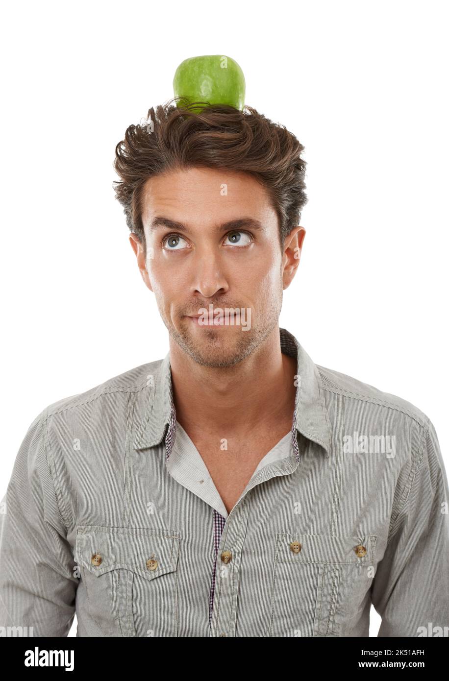 Hes got healthy eating on his mind. A handsome young man balancing an ...