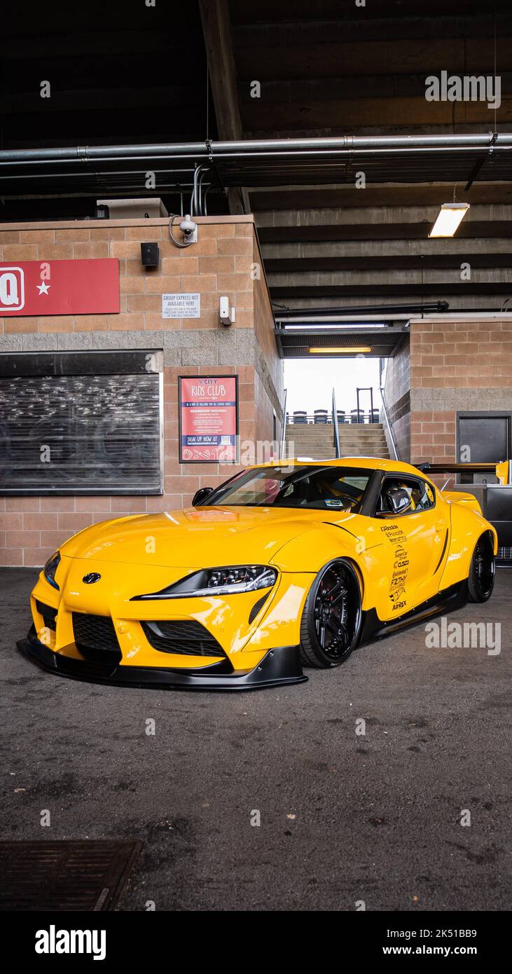 A vertical shot of a yellow Toyota Supra with modern design Stock Photo ...